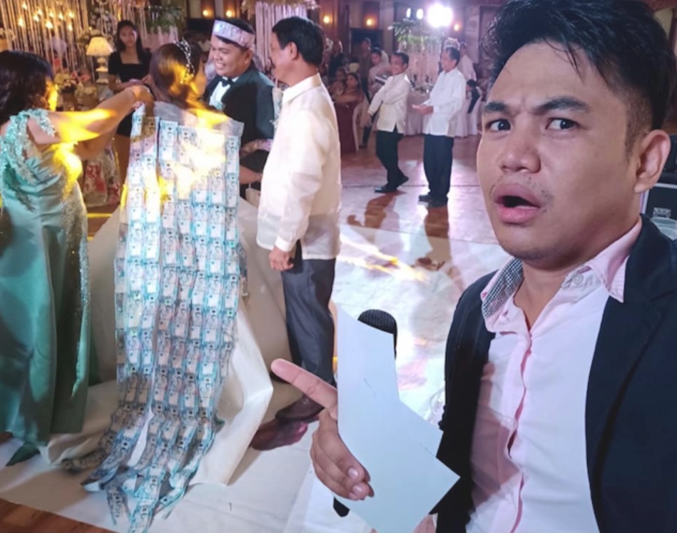 Isang kasalan ang usap-usapan ngayon dahil sa libu-libong pera na nakasabit sa mga damit ng ...